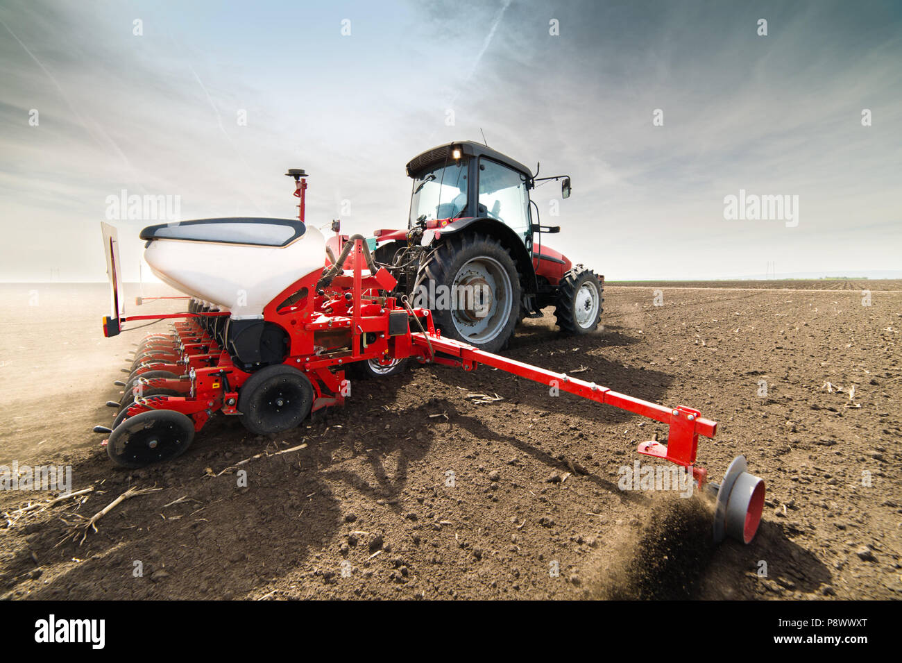 Farmer seeding crops at field Stock Photo - Alamy