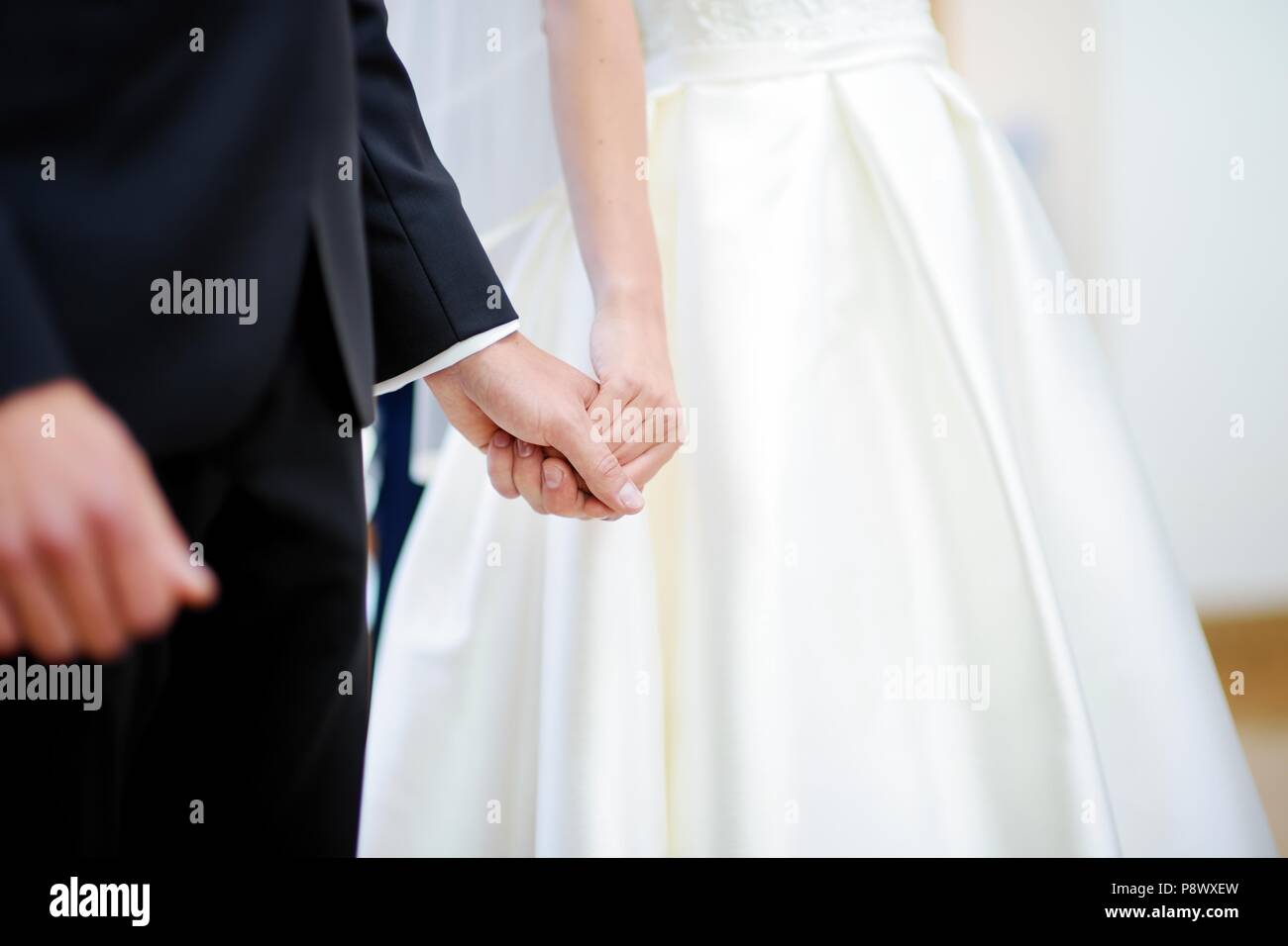 Bride and groom holding their hands during wedding ceremony Stock Photo ...