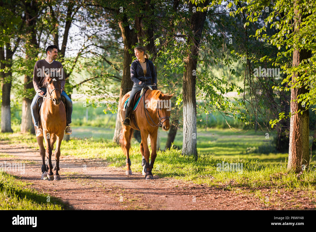 Young couple in love riding a horse Stock Photo - Alamy