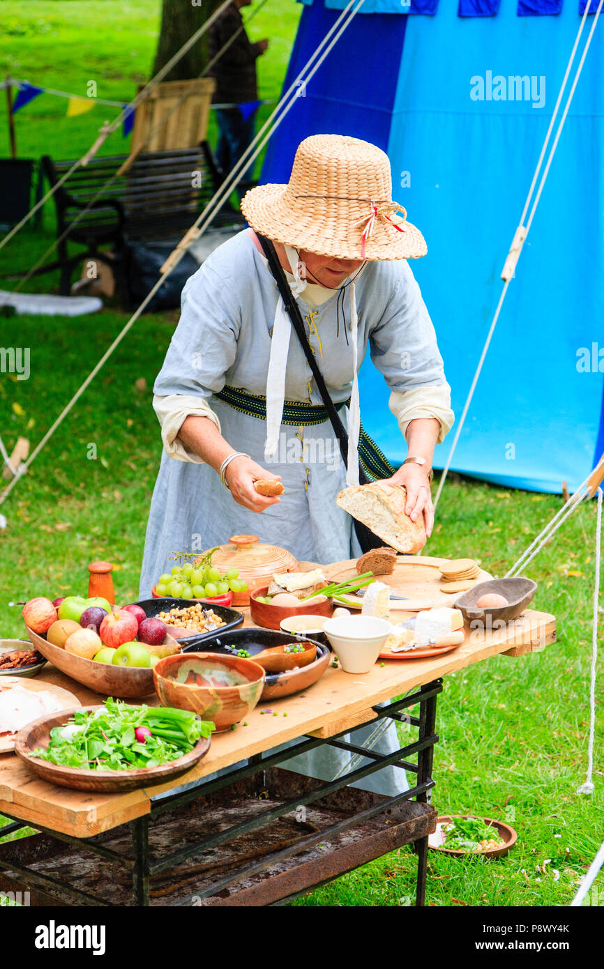Reenactment, living history event. Woman in medieval costume, taking ...