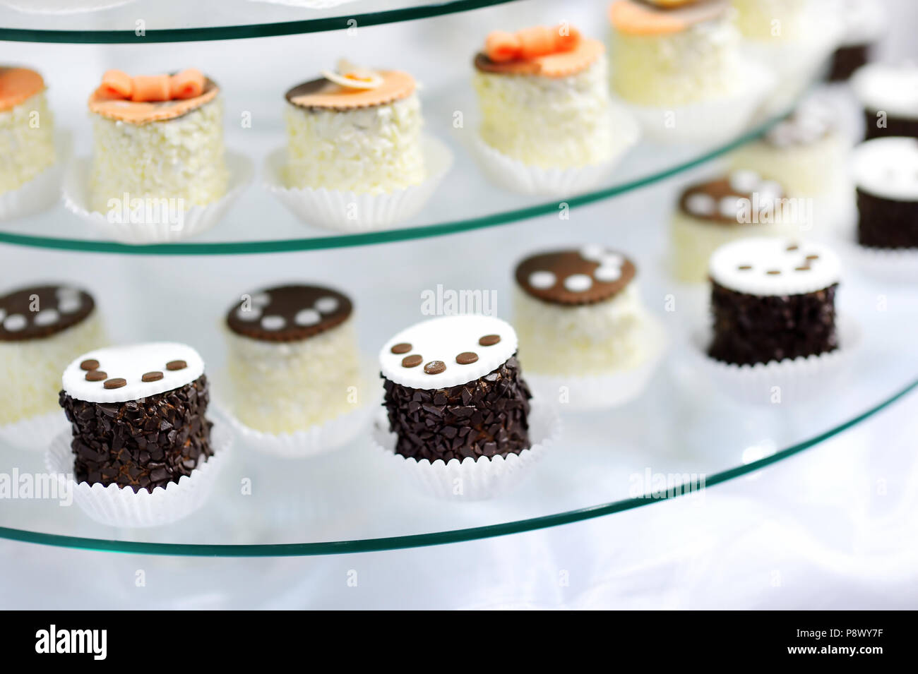 Decorated colorful cupcakes on a glass plate Stock Photo - Alamy