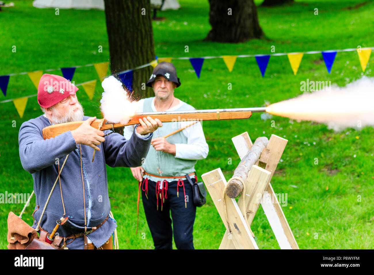 Man in medieval costume, firing harquebus, arquebus, early ...