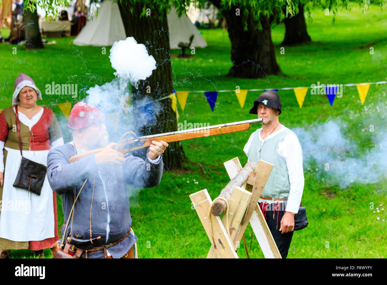Man in medieval costume, firing harquebus, arquebus, early ...