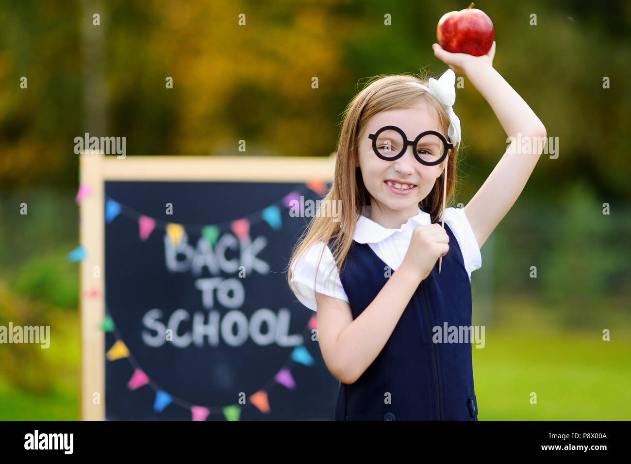 Adorable little girl feeling very exited about going back to school ...