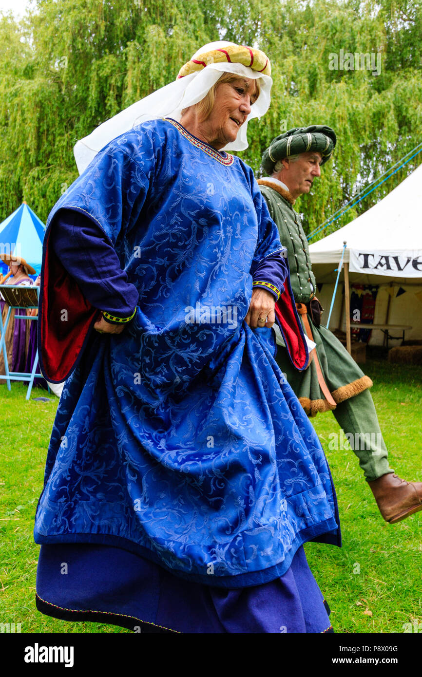 Medieval dancing outdoors. Living history couple dressed in traditional ...