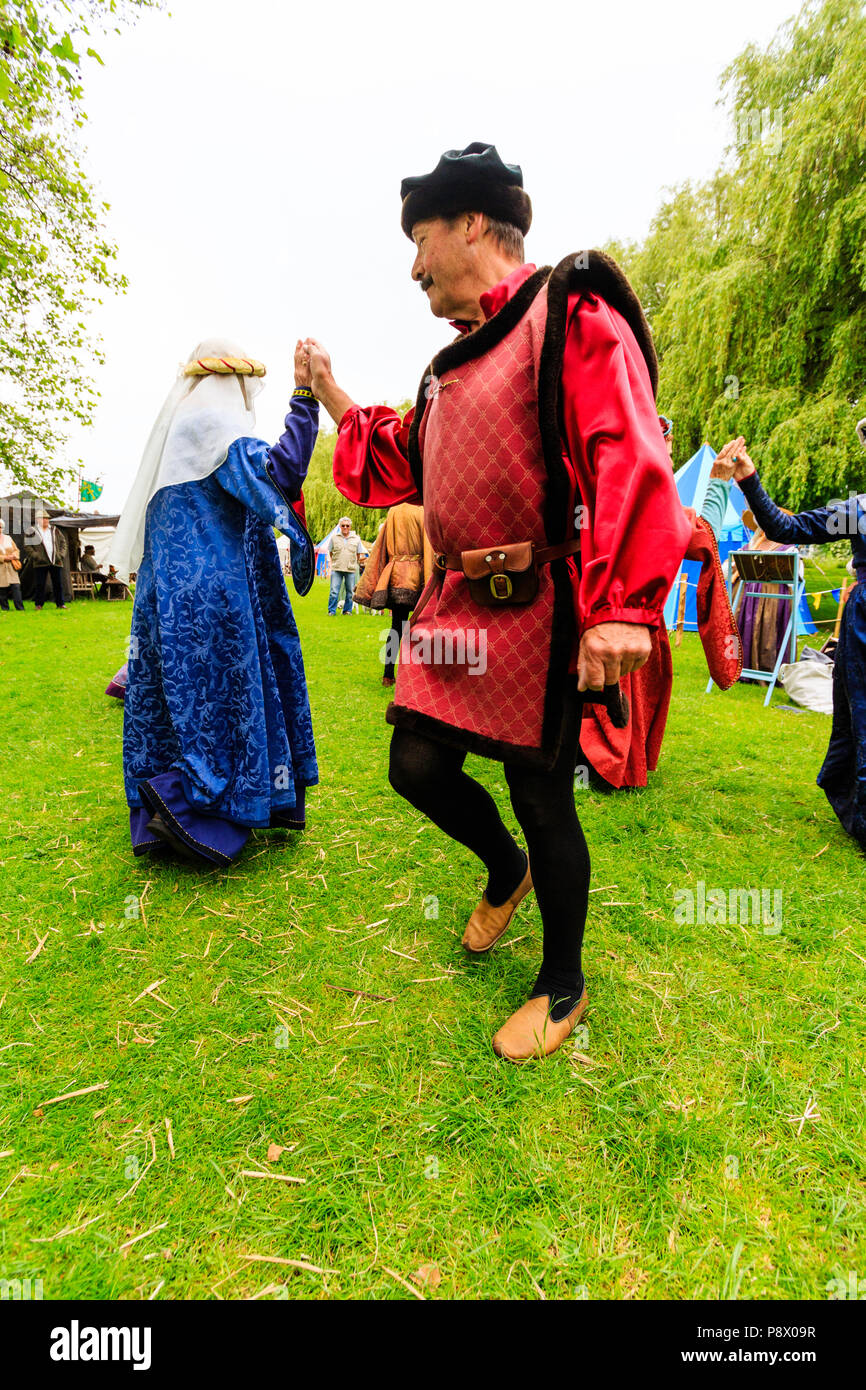 Medieval dancing outdoors. Living history group of people dressed in ...