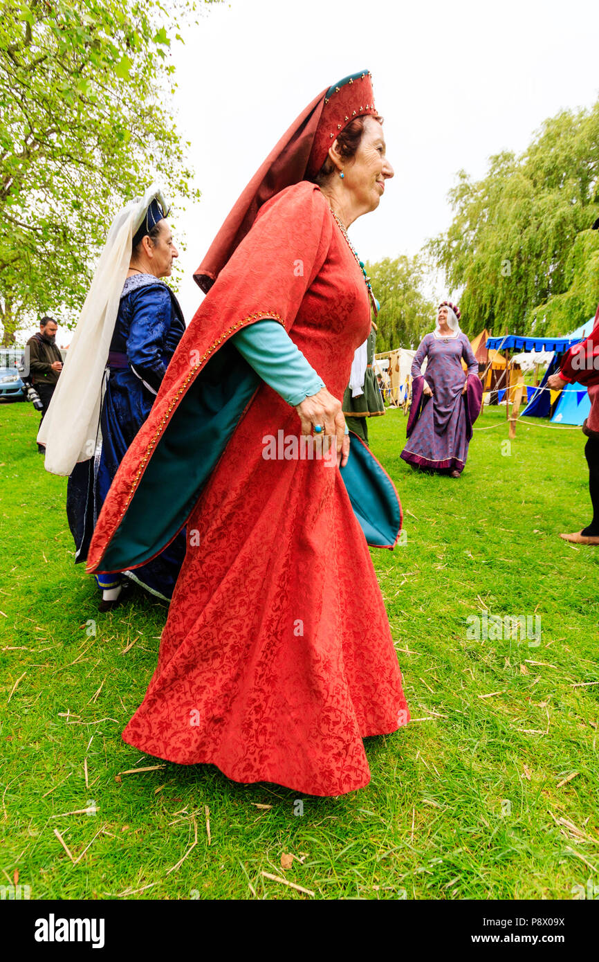 Medieval dancing outdoors. Living history group of people dressed in ...