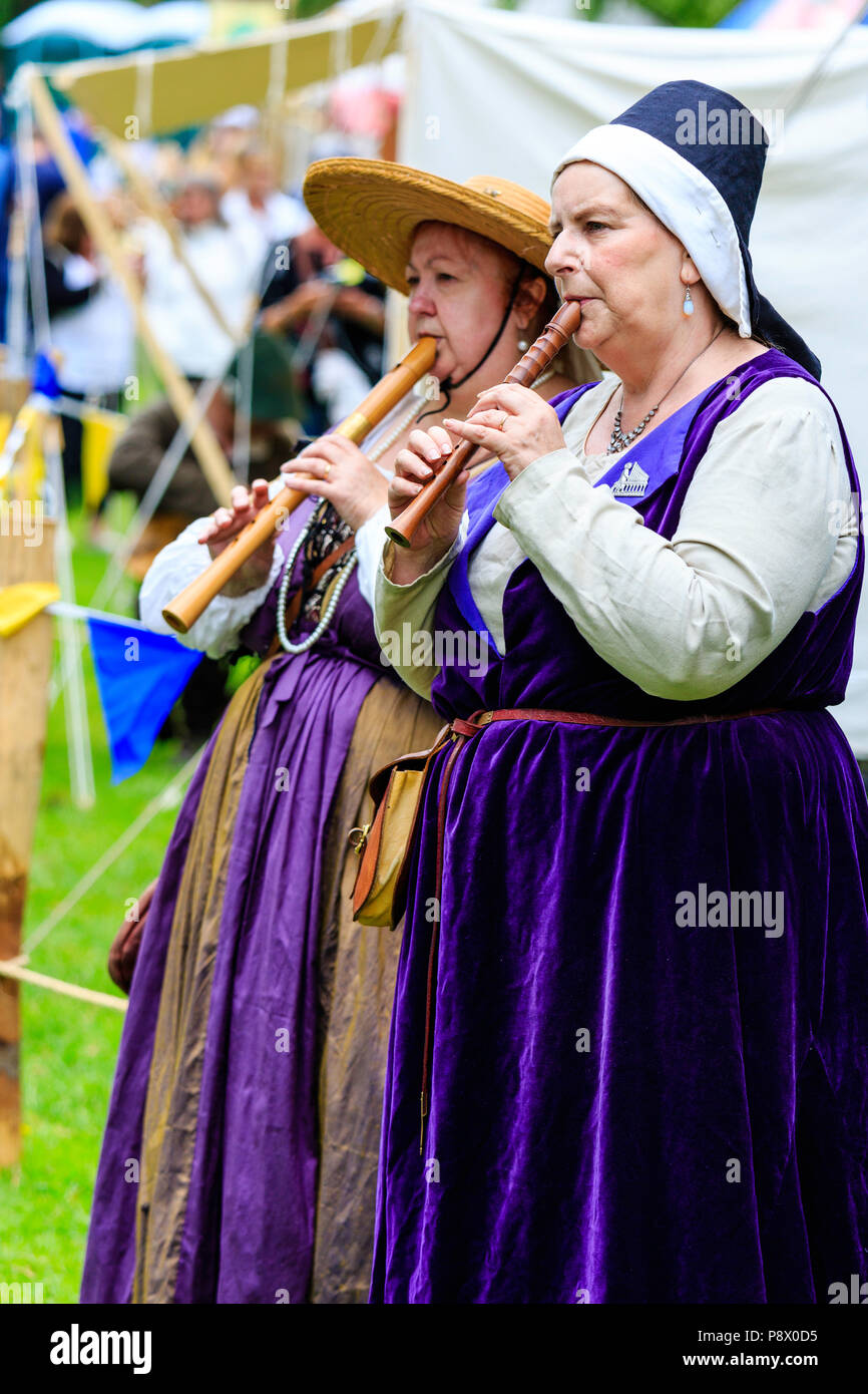 Two women wearing outfits of medieval traveling minstrel, entertainer ...