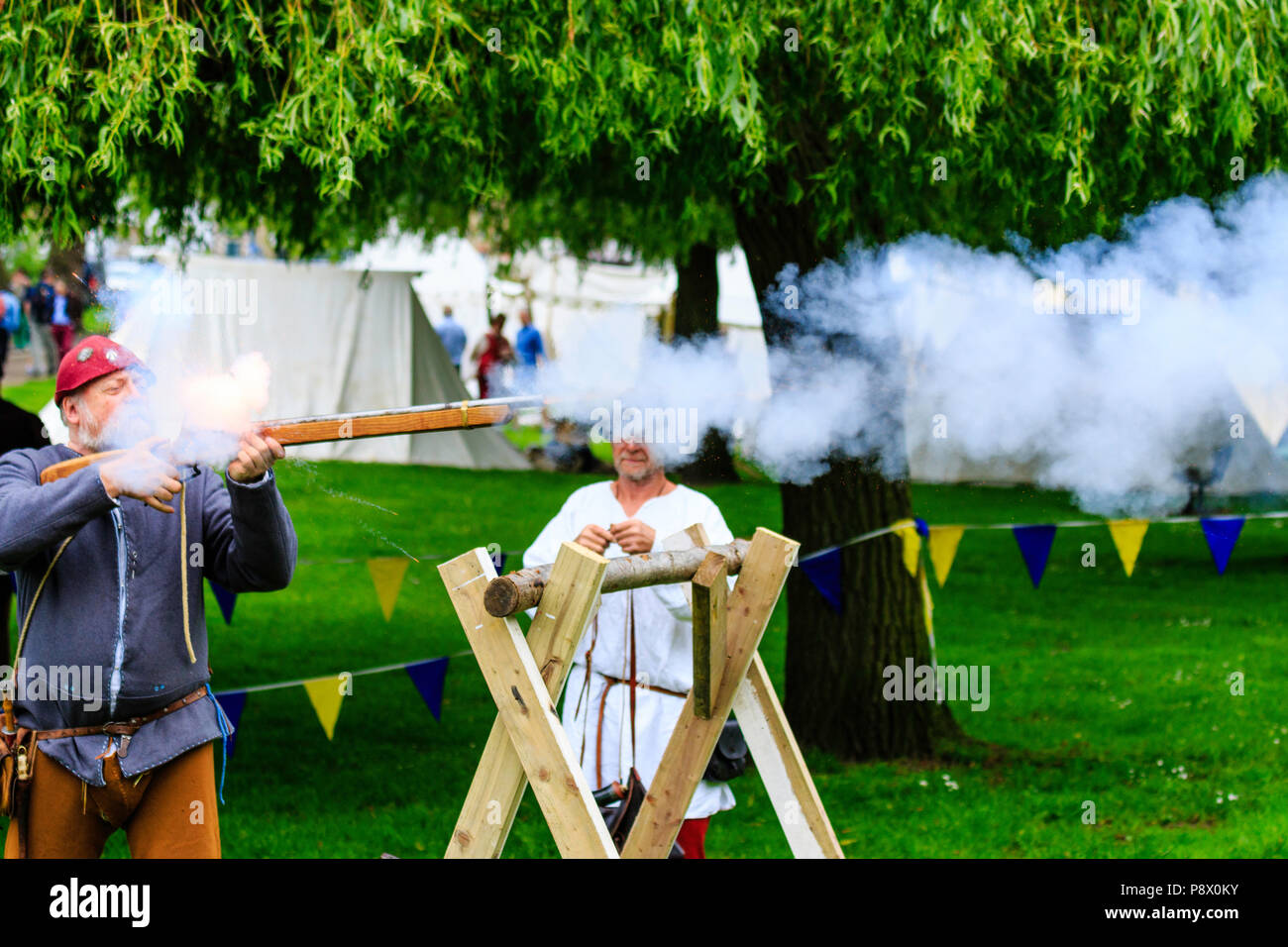Man in medieval costume, firing harquebus, arquebus, early ...