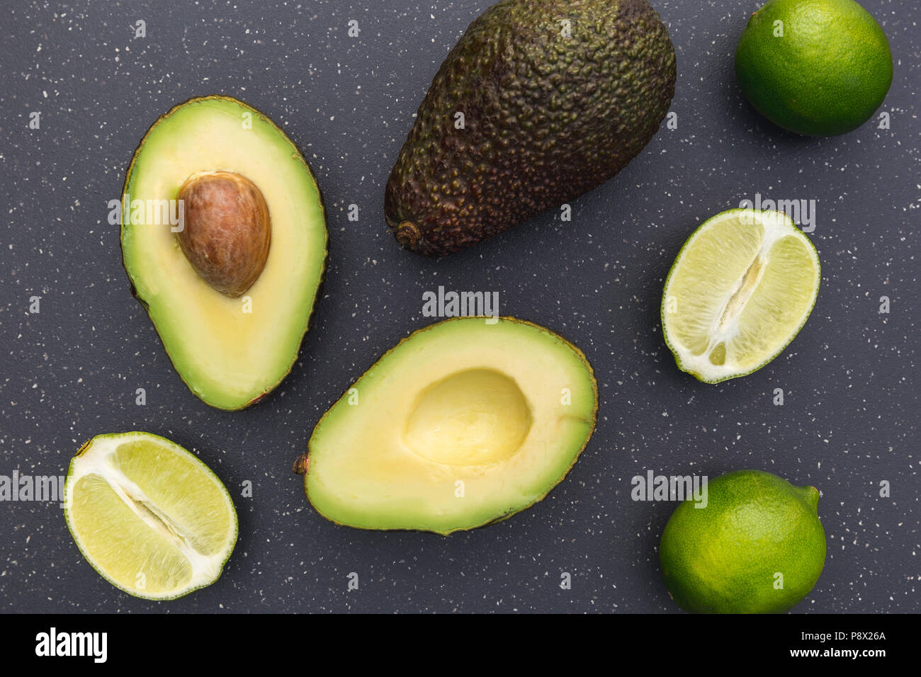Avocado half on dark background overhead view Stock Photo - Alamy