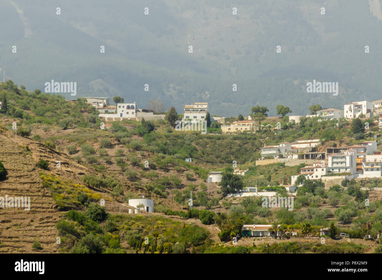 typical spanish village houses and farmland in the hills of andalusia ...
