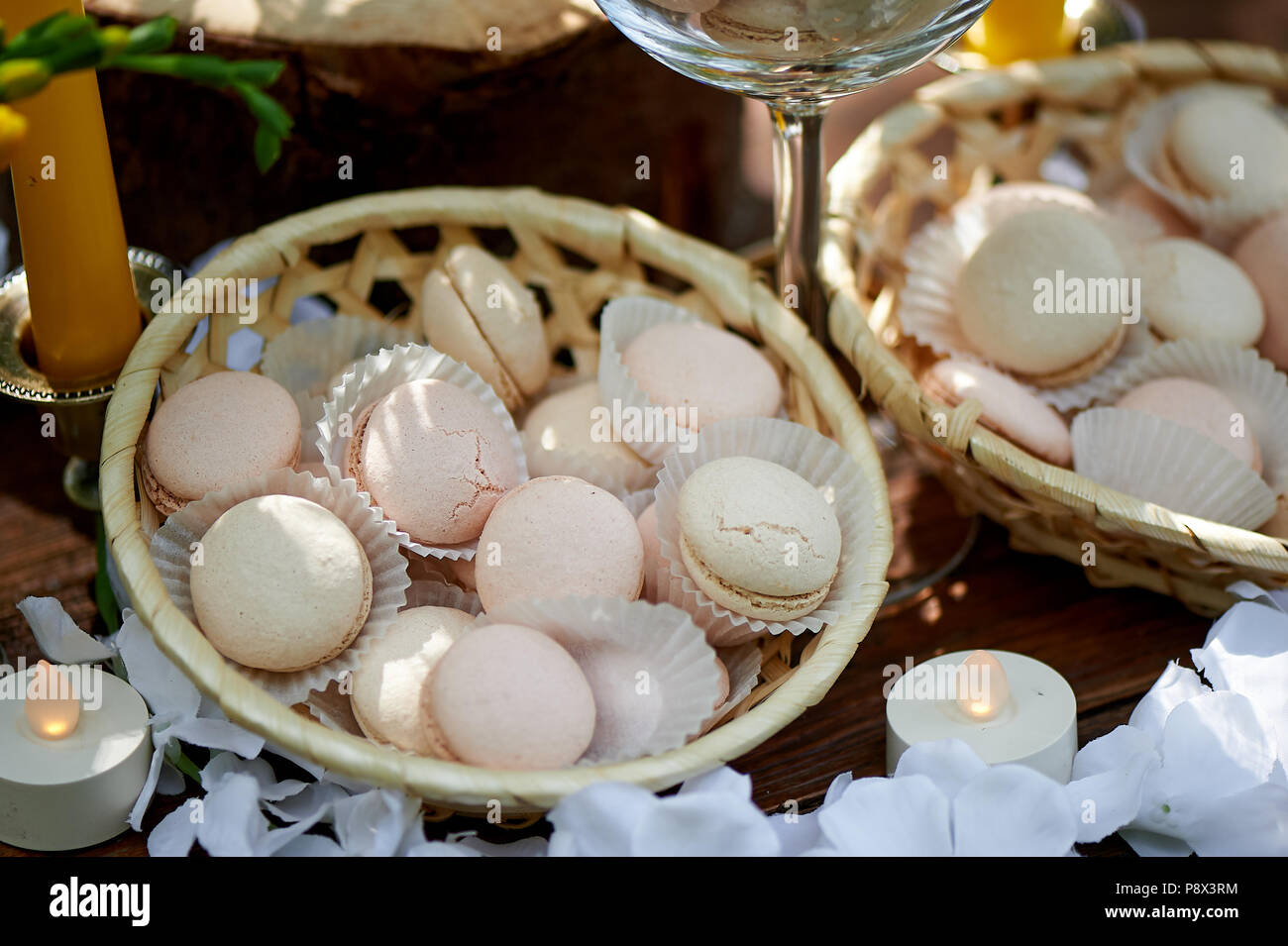 Catering for the wedding Banquet. Macaroons in vases, cream and yellow ...