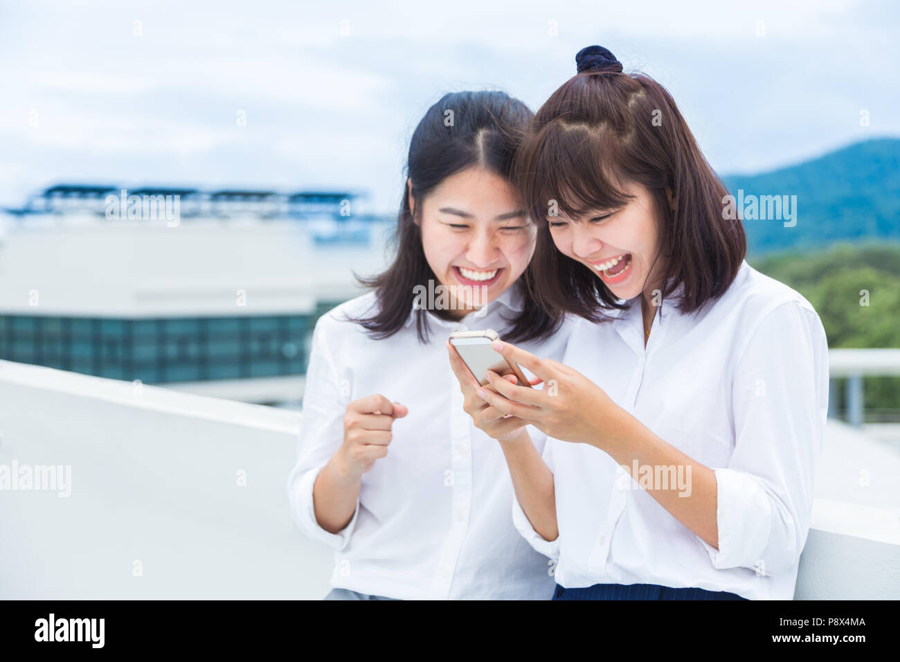 Happy Asian women enjoy using their smart phone to connect to social ...