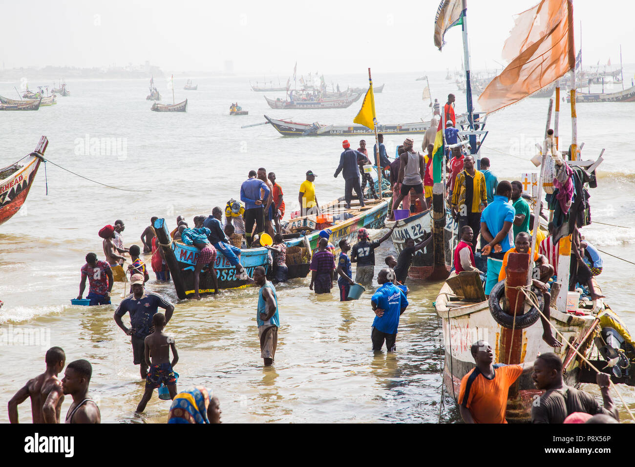 Fishing boats in the sea with fishermen, Accra, Ghana Stock Photo - Alamy