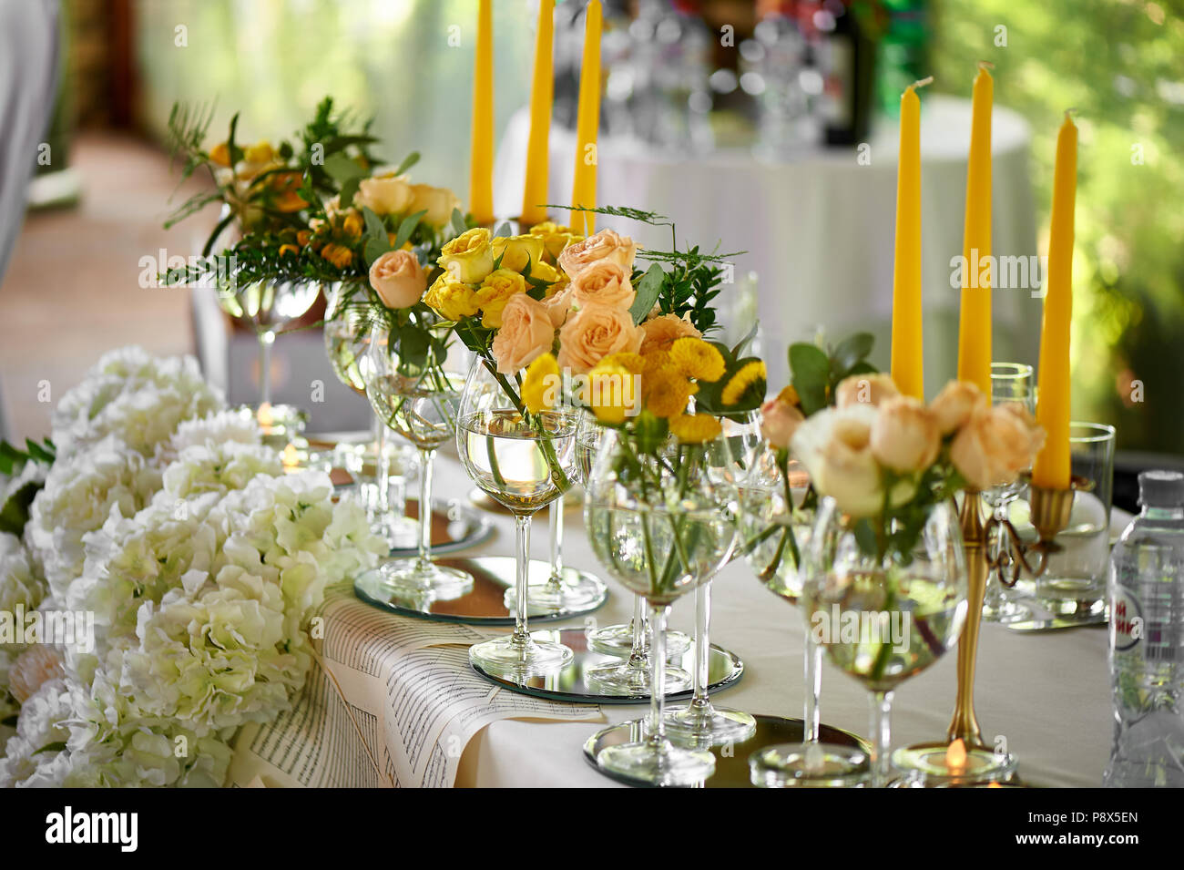 Yellow flowers details of the wedding table decorated with flowers ...