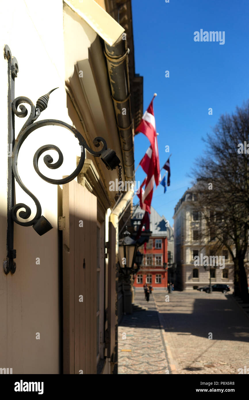 At home with national flags on the street of old Riga in the holiday by ...