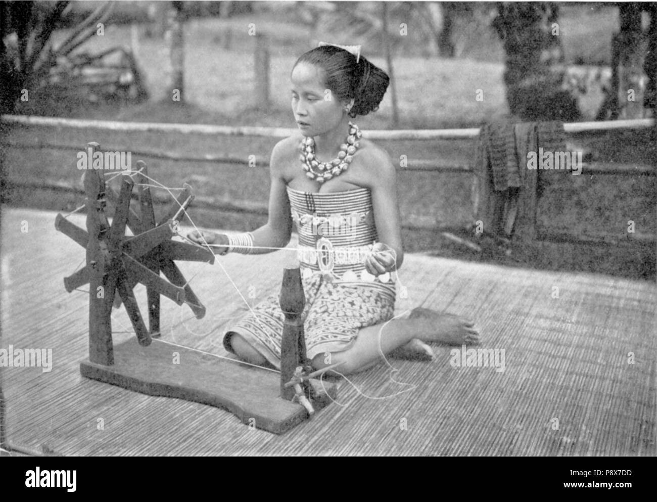 . 89 Dayak girl spinning wheel ca1900 Stock Photo - Alamy