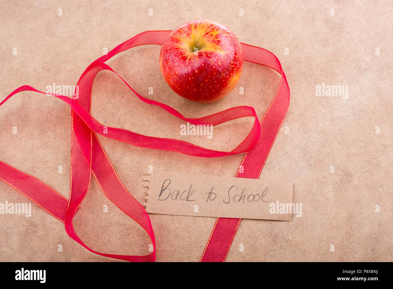 Back to school lettering with apple and a red ribbon Stock Photo - Alamy