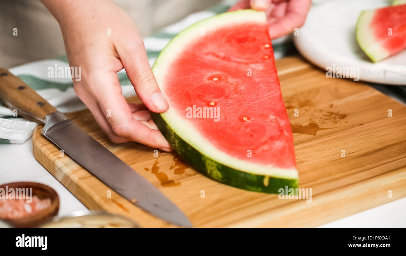 Slicing watermelon into cubes for preparing chocolate covered ...