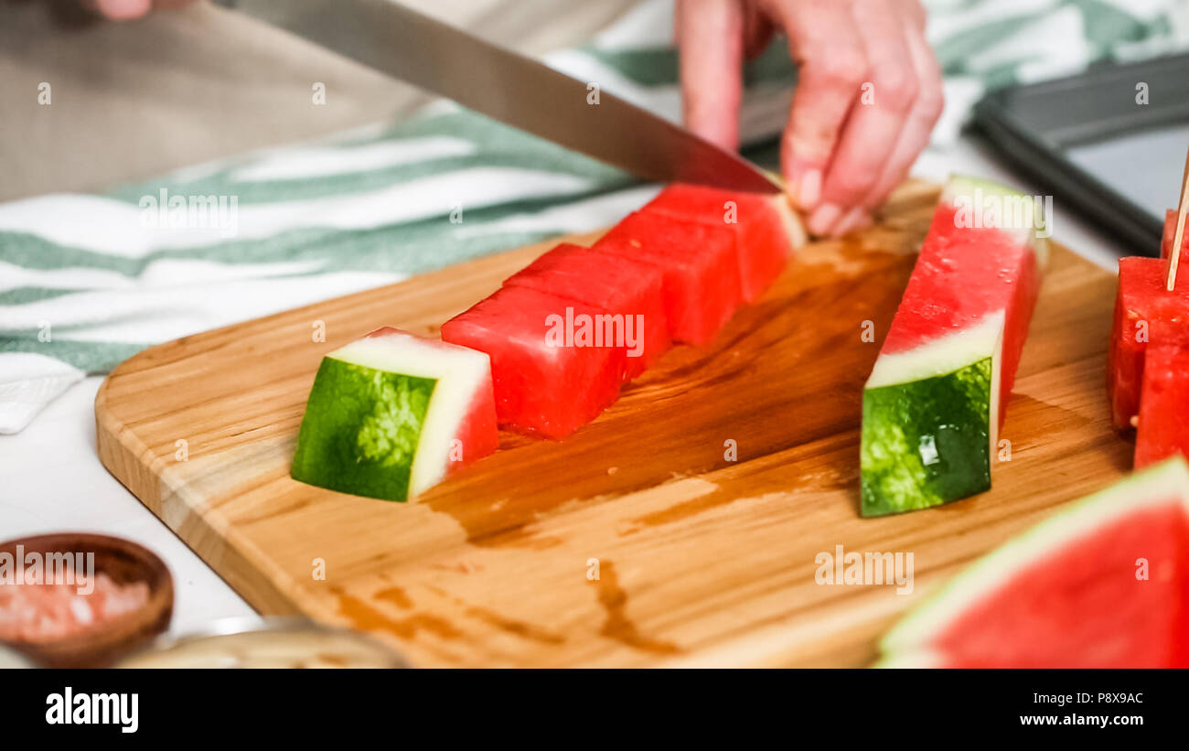 Slicing watermelon into cubes for preparing chocolate covered ...