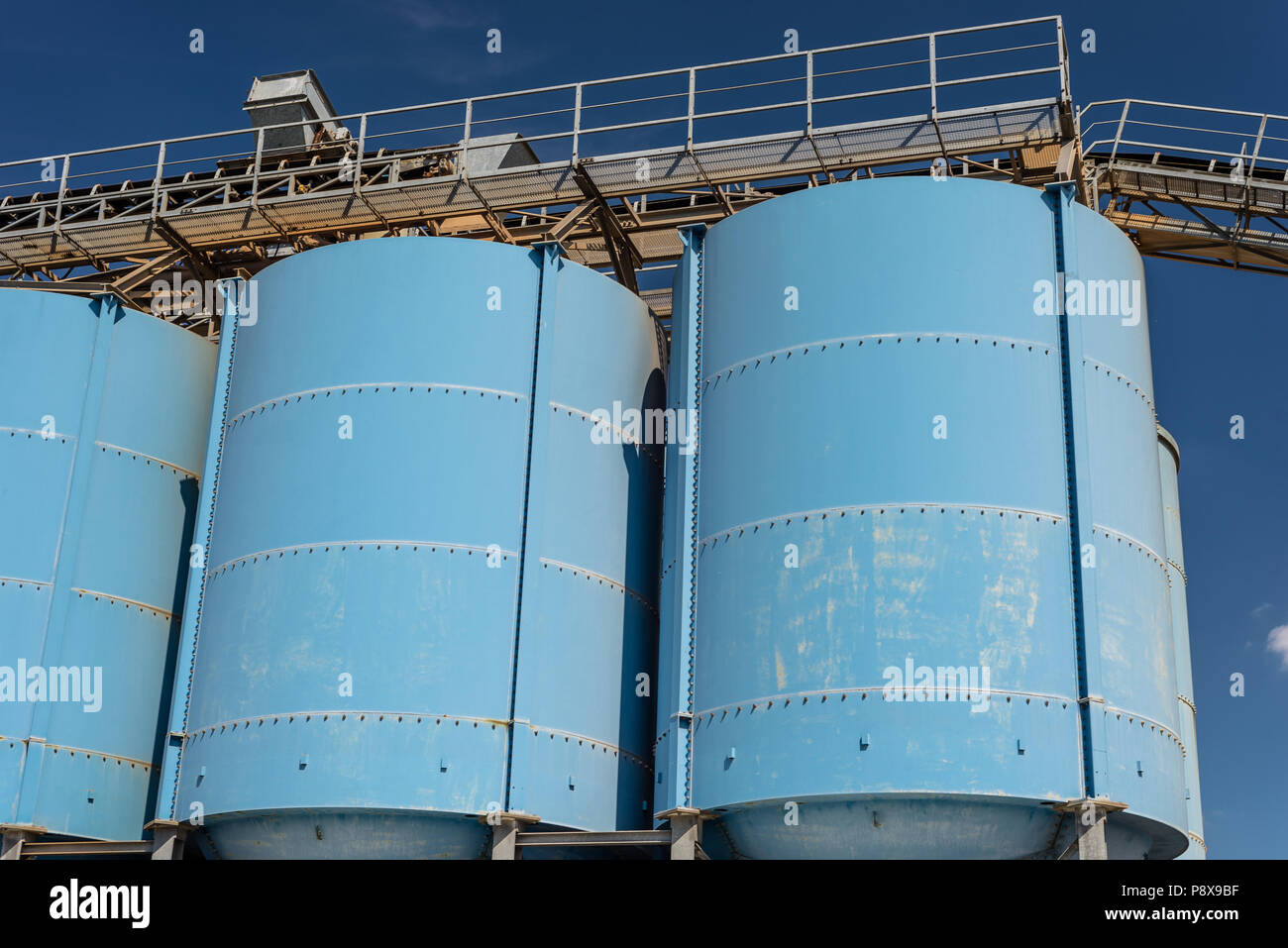 Big blue metallic Industrial silos for the production of cement at an ...