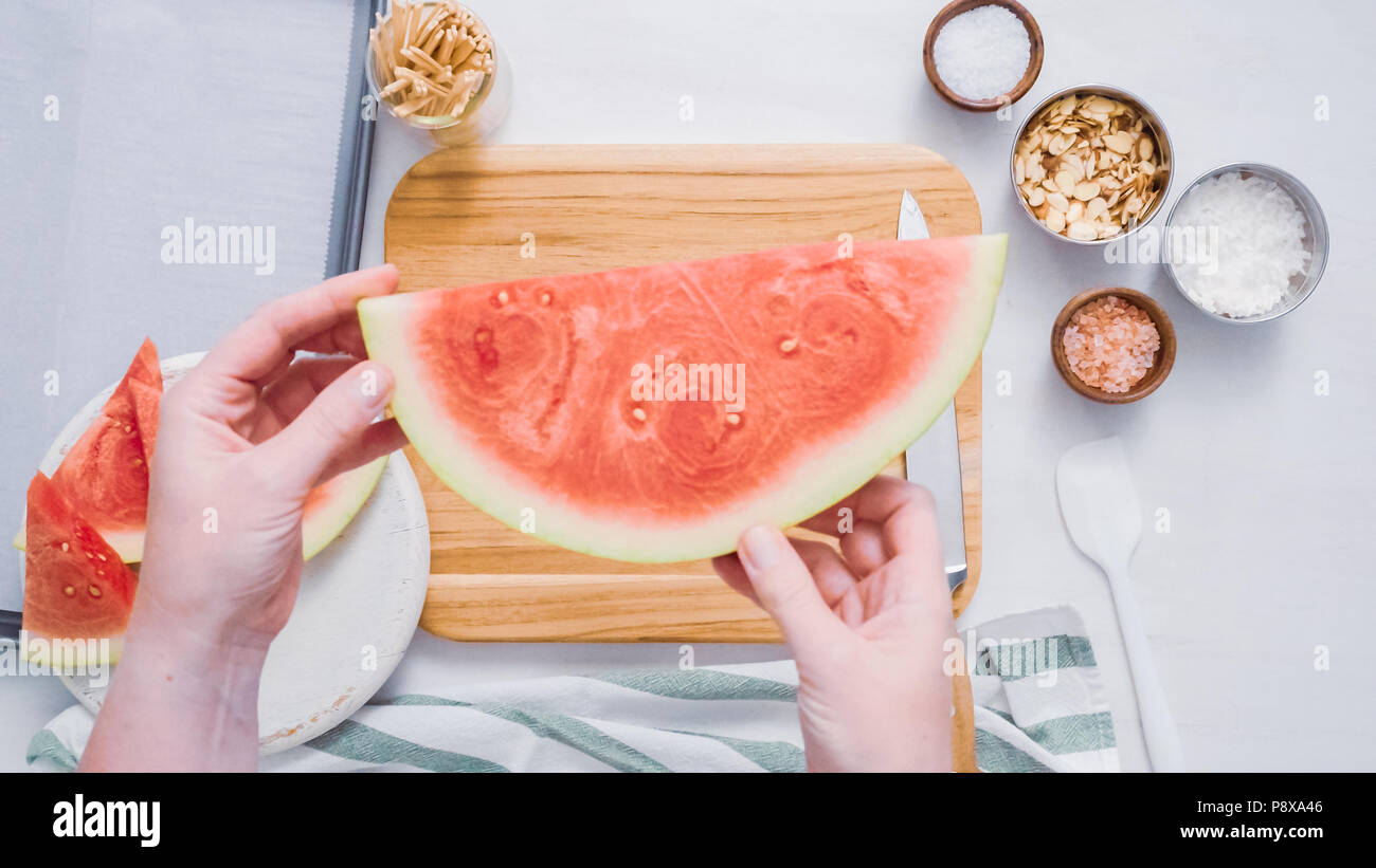 Slicing watermelon into cubes for preparing chocolate covered ...