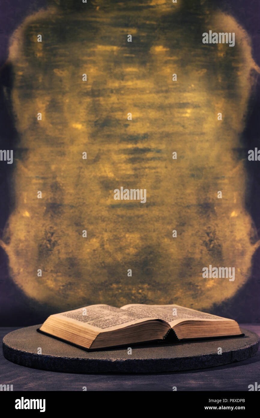 Open Holy Bible on a stone round table. Beautiful Gold background ...