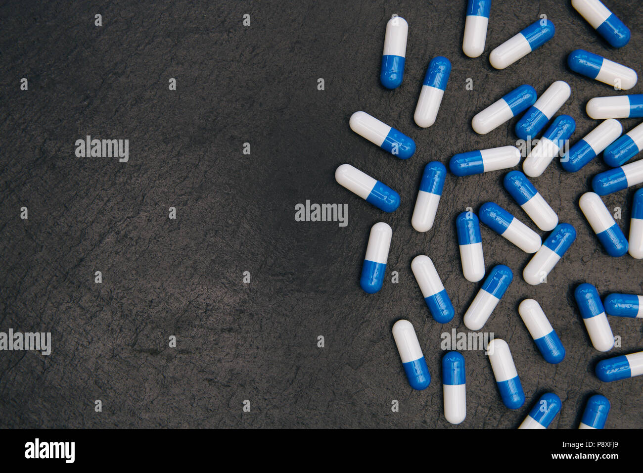 Drugs pills capsules heap on dark background with copy space Stock ...