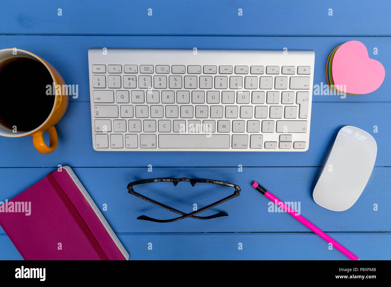 Computer keyboard on bright blue background minimal office concept ...