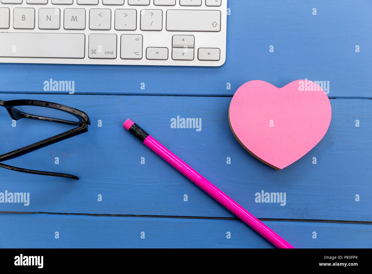 Computer keyboard on bright blue background minimal office concept ...