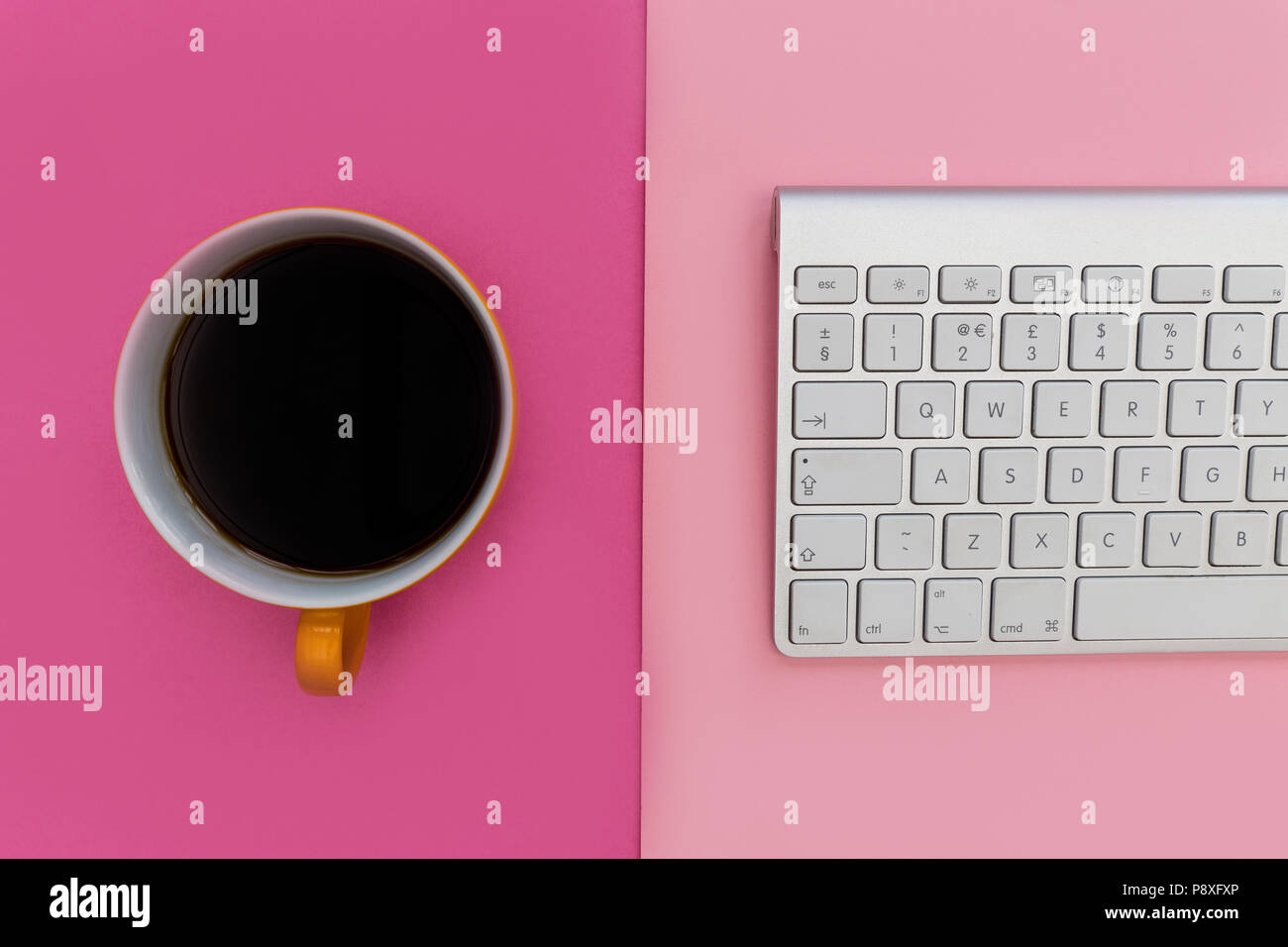 Computer keyboard on bright pink background minimal workspace concept ...