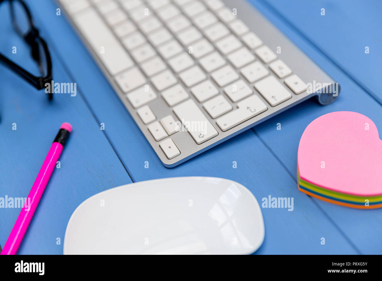 Computer keyboard on bright blue background minimal office concept ...