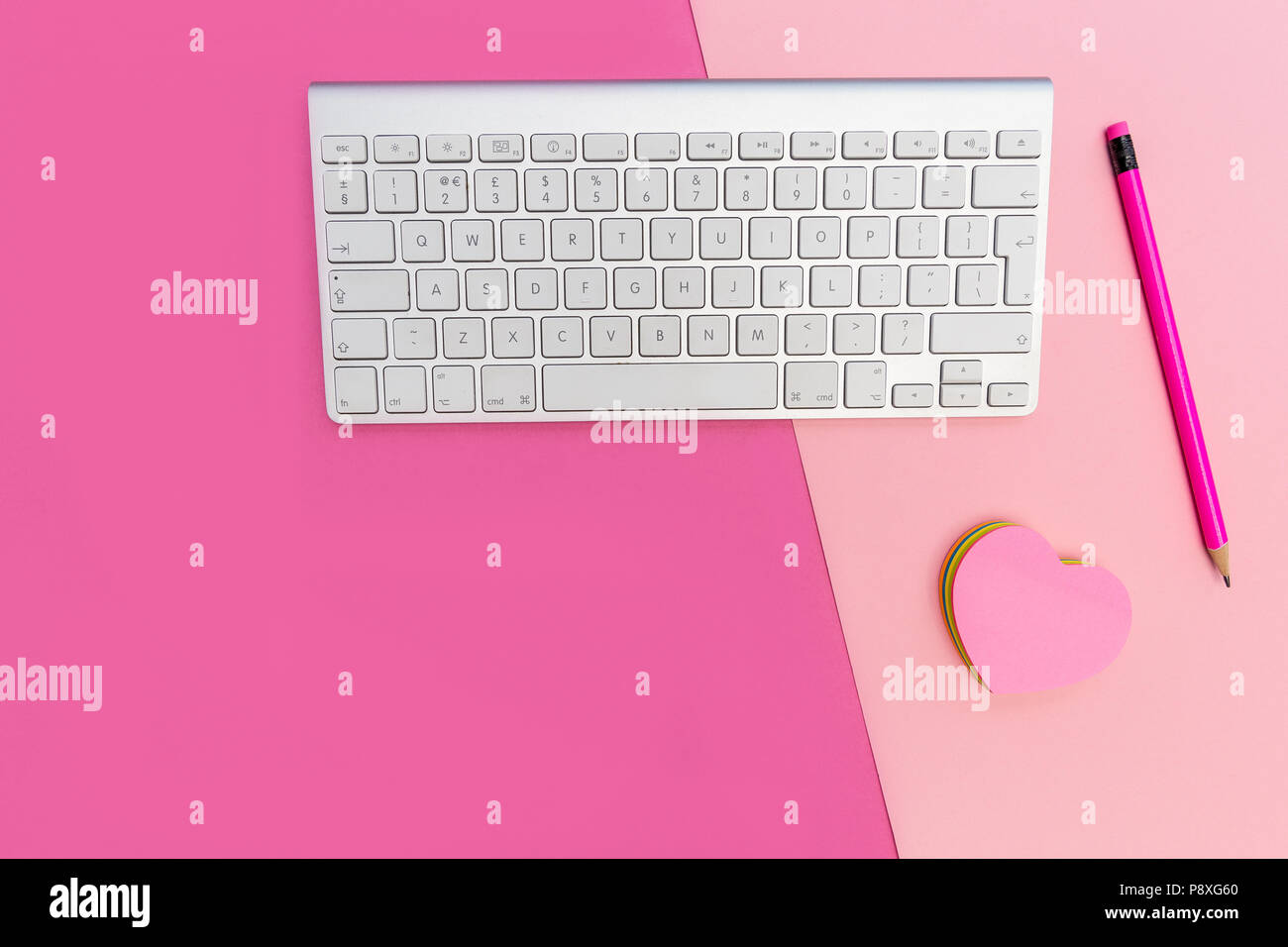 Computer keyboard on bright pink background minimal workspace concept ...