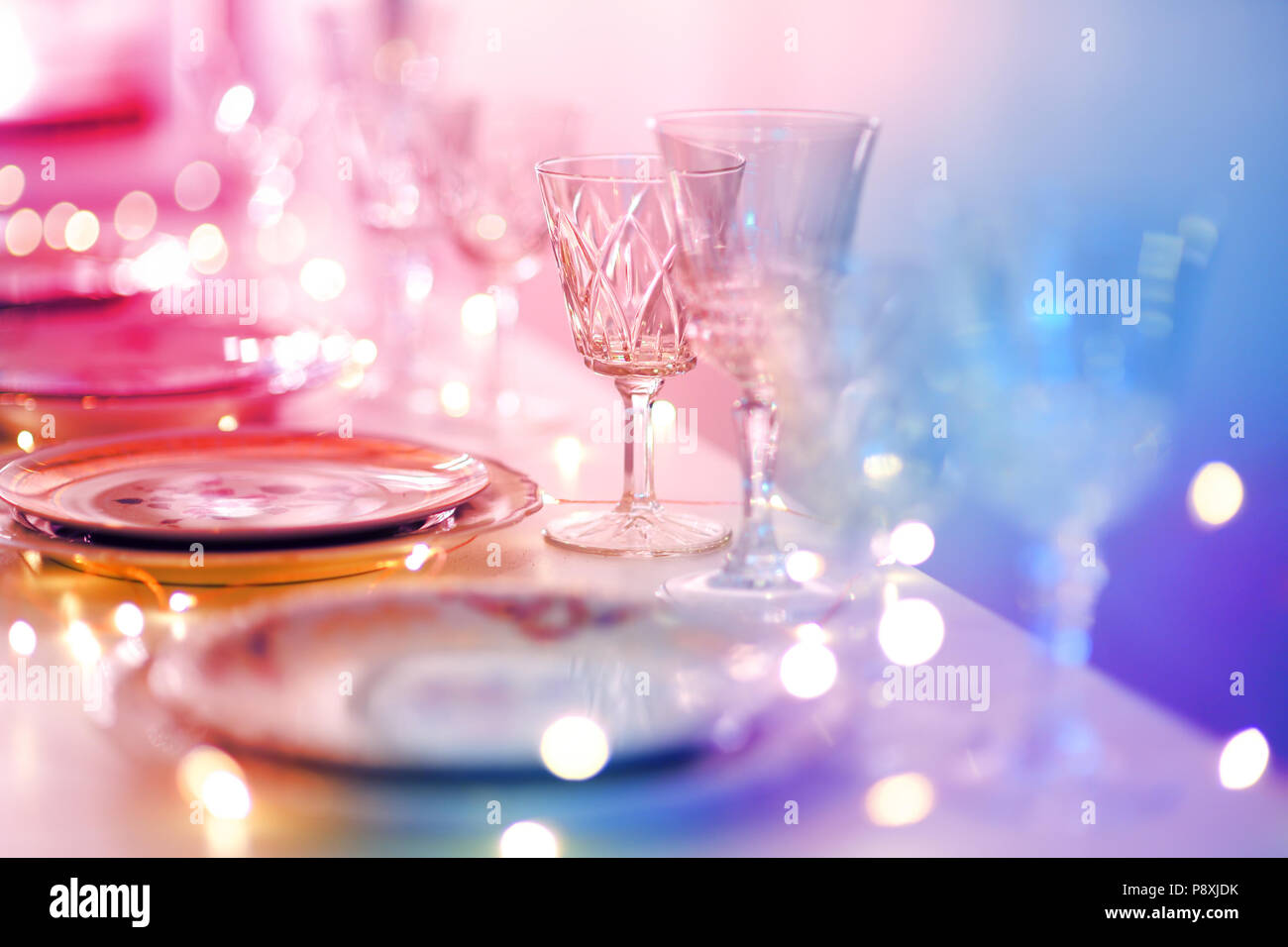 Table set for an event party or wedding reception in purple light Stock ...