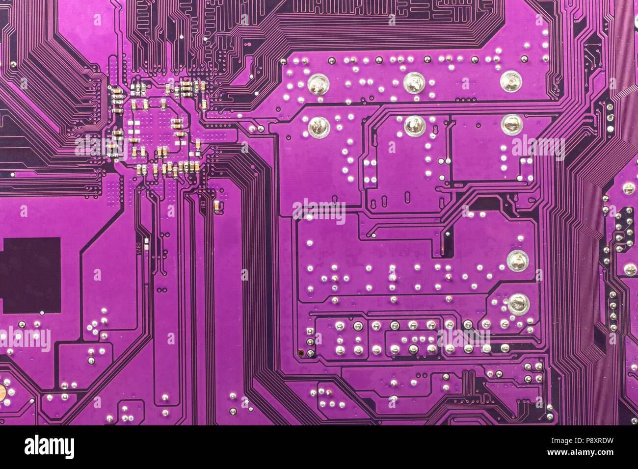 Violet circuit board background of computer motherboard.Computer chip ...