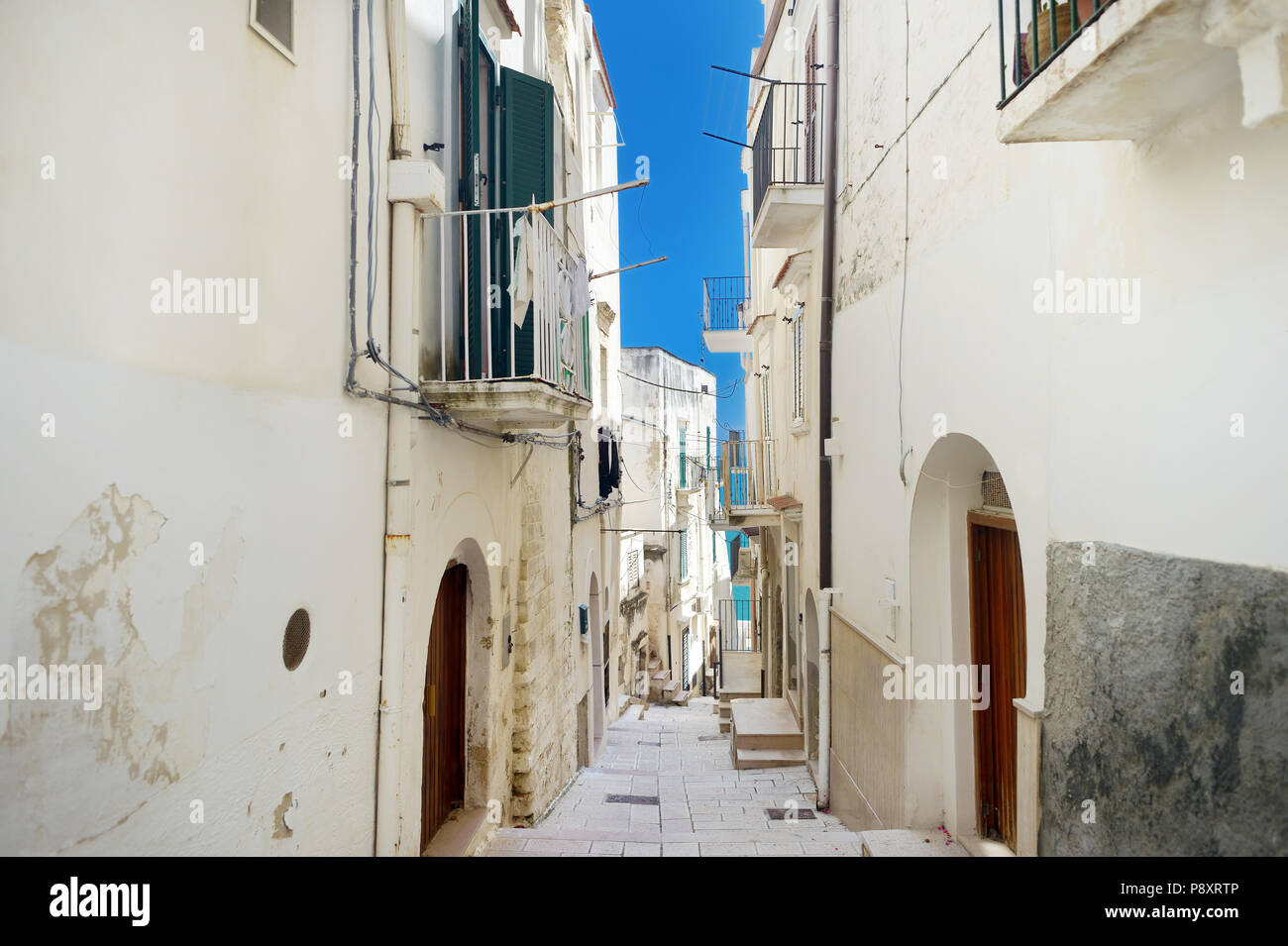 Typical medieval narrow street in beautiful town of Vieste, Italy Stock ...