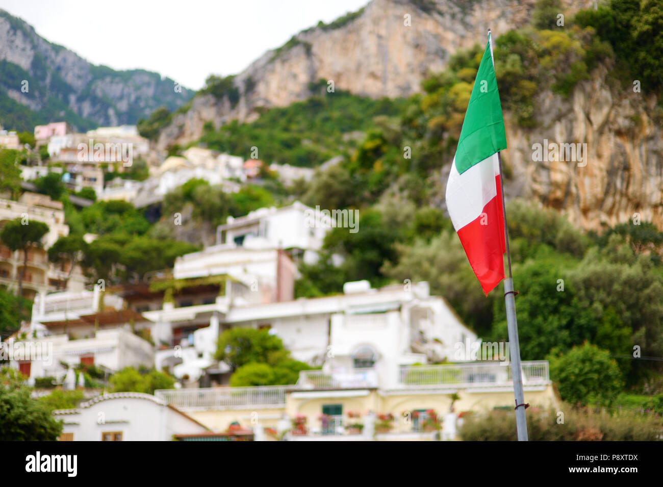 Italian flag over beautiful town of Positano at famous Amalfi coast ...