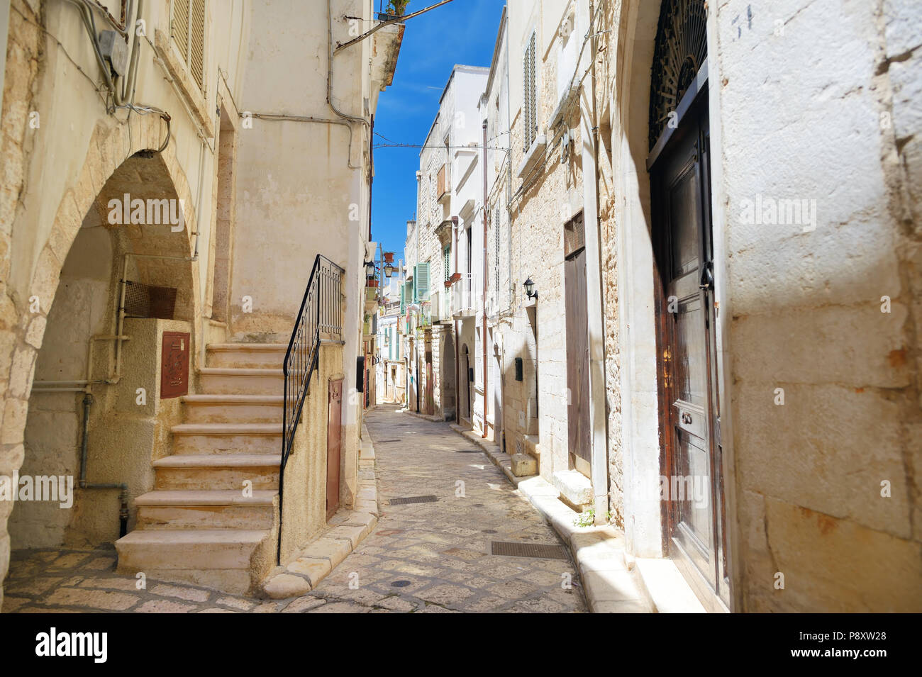 Typical medieval narrow street in beautiful town of Conversano, Italy ...
