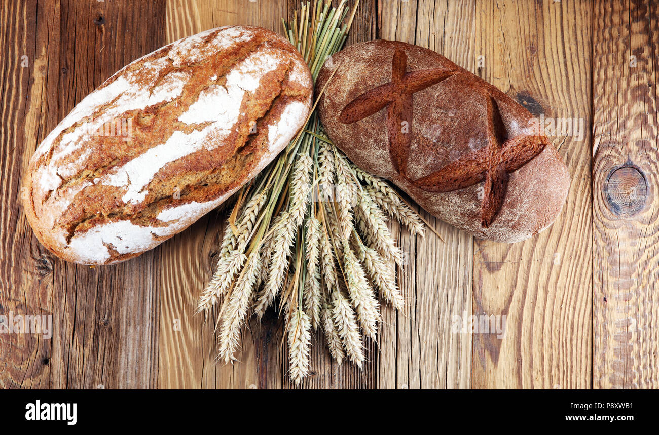 Different kinds of bread and bread rolls on board from above. Kitchen ... Different kinds of bread and bread rolls on board from above. Kitchen ...