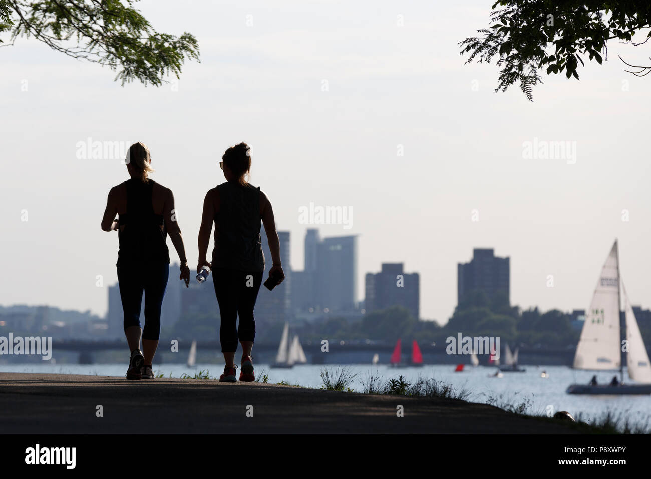 Two people women walking on the Esplanade on the Charles River, Boston ...