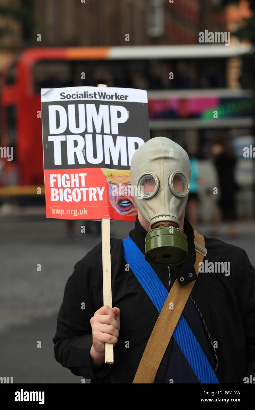 A demonstrator wearing a gas mask in Albert Square, Manchester, as part ...