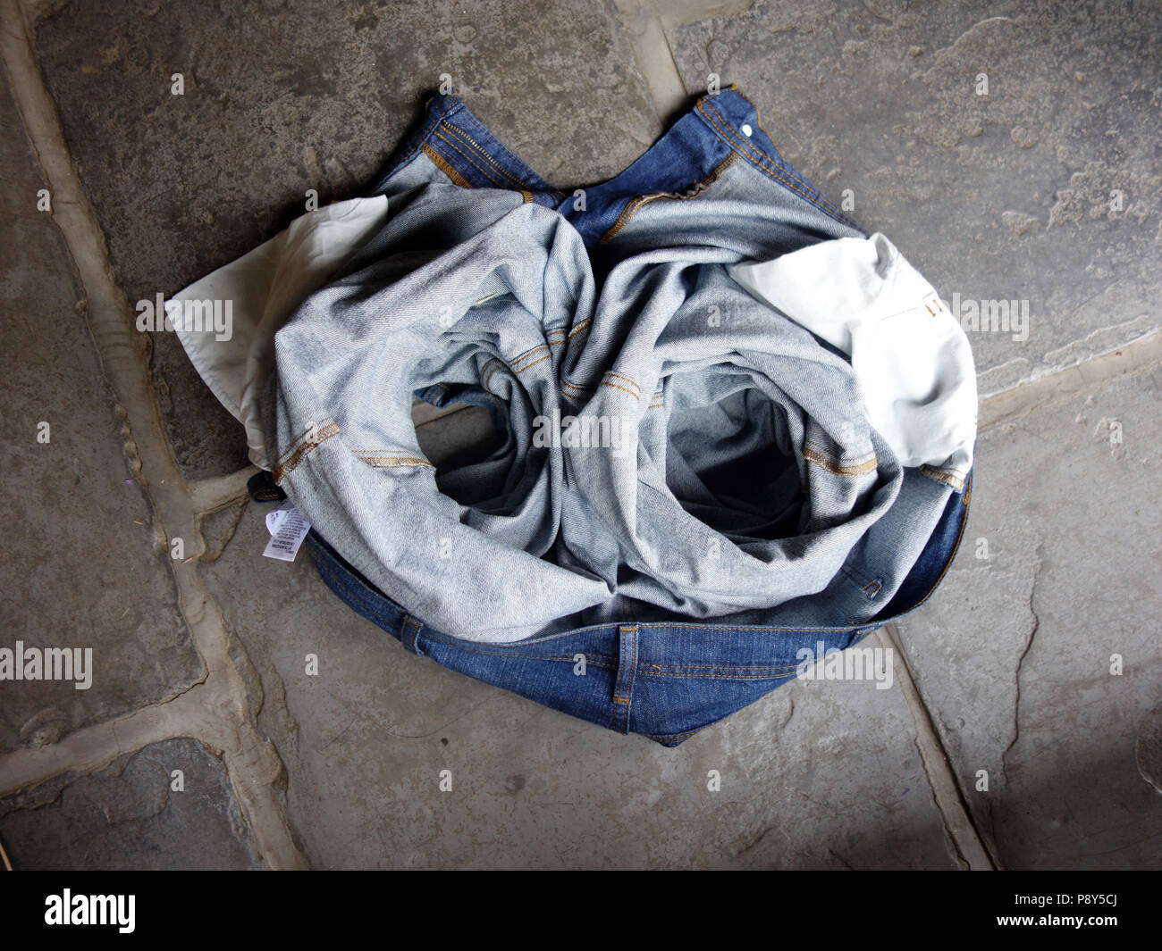 mens jeans on floor as they were stepped out of Stock Photo - Alamy