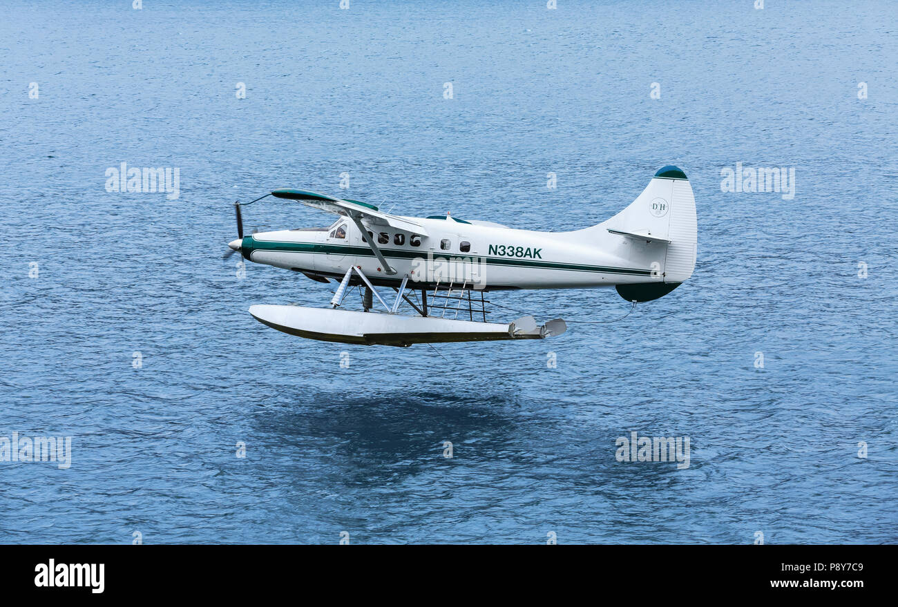 A Small Sea Plane Taking Off over blue water in Alaska Stock Photo - Alamy