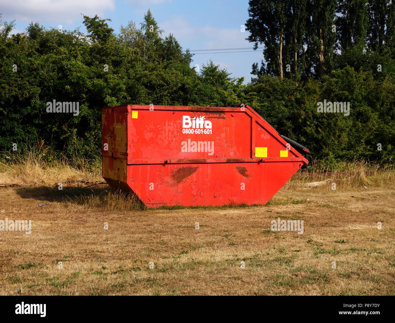 A skip is a large open-topped waste container designed for loading onto ...