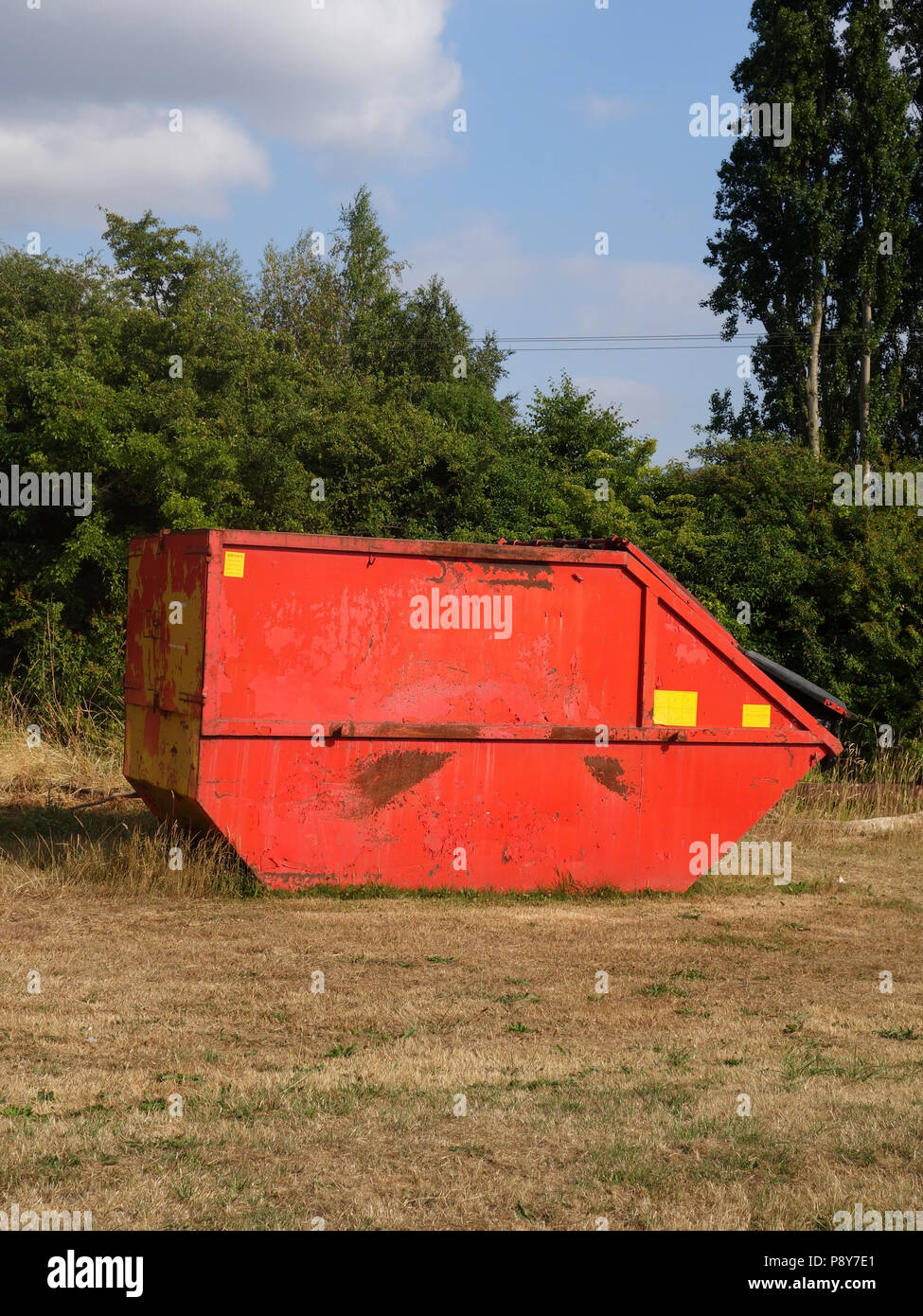 A skip is a large open-topped waste container designed for loading onto ...