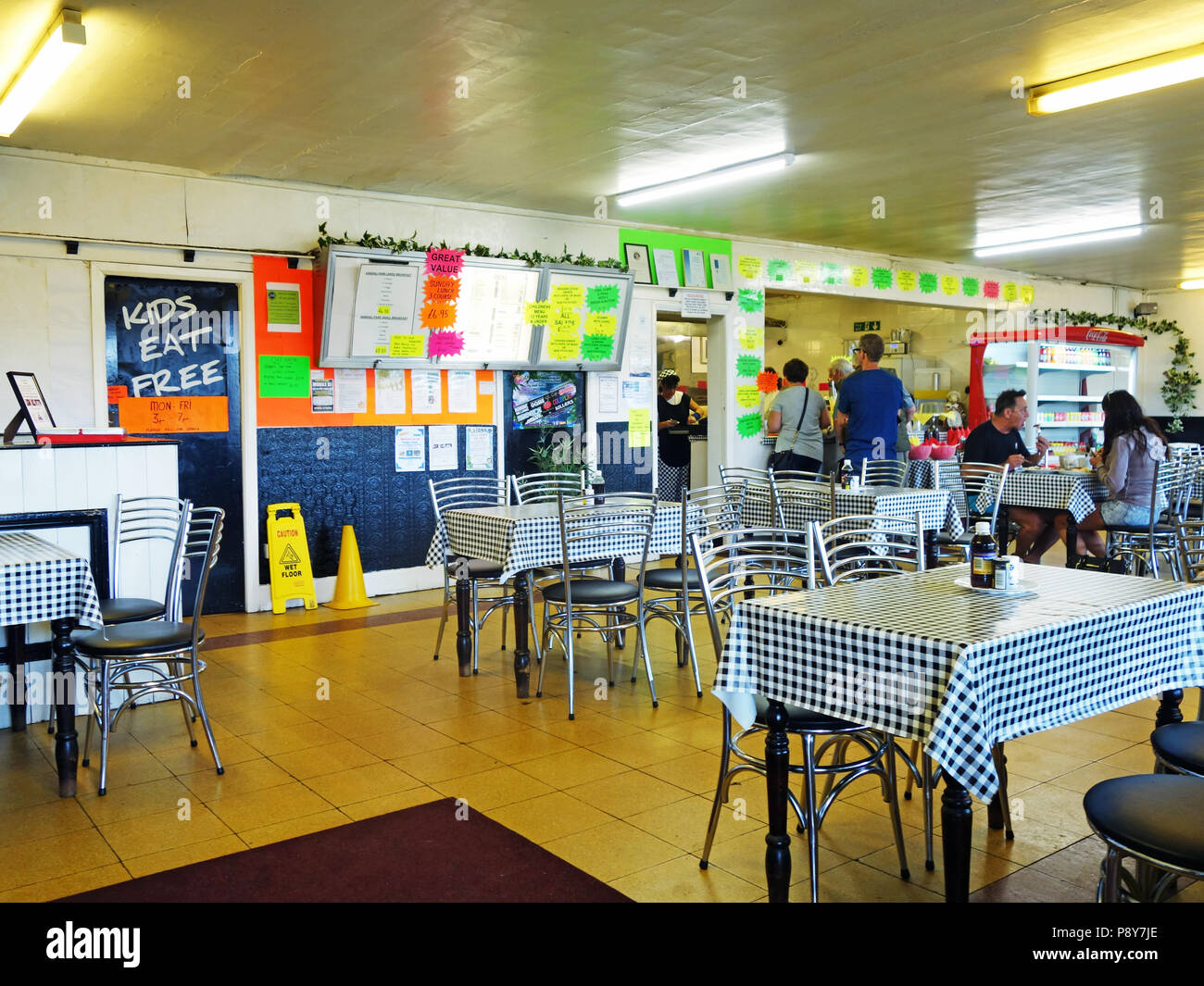 Old fashioned style cafe table and chairs with checkered tablecloth ...