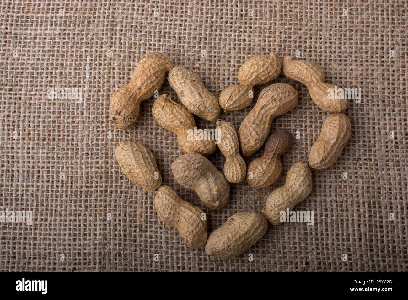 Peanuts form a heart shape on canvas background Stock Photo - Alamy