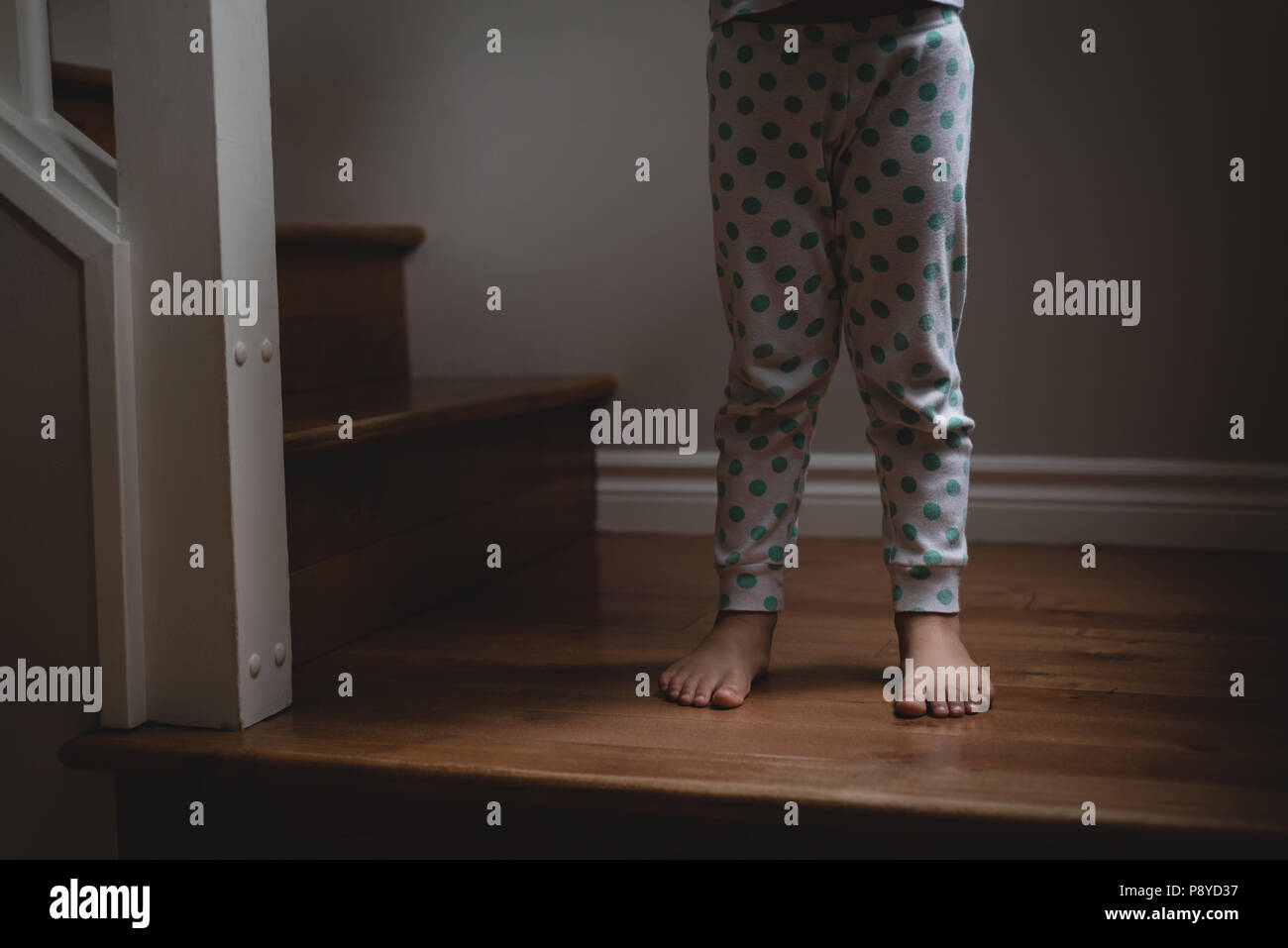 Lower section of girl standing on stairs Stock Photo - Alamy