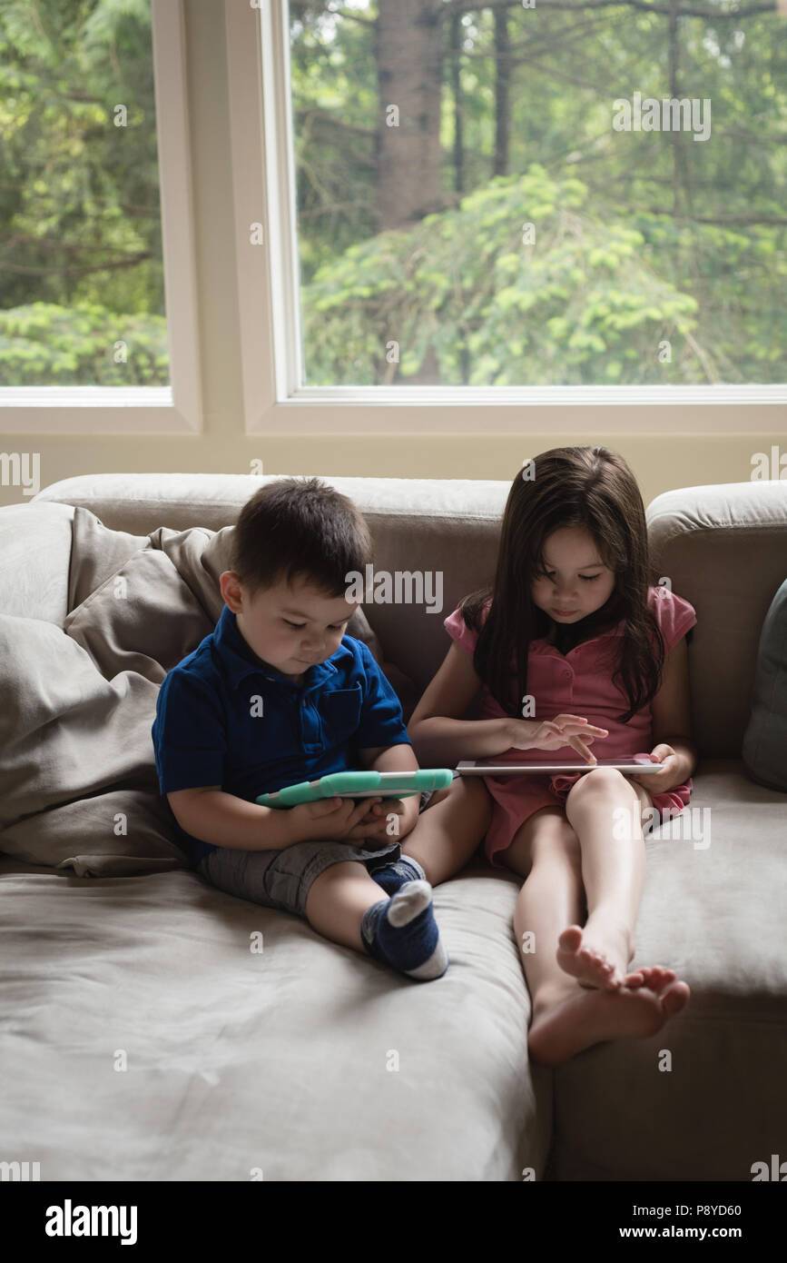 Asian siblings using wireless tablet hi-res stock photography and images - Alamy