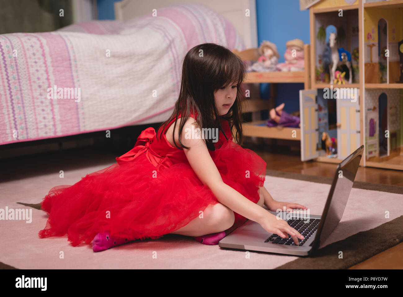Girl using laptop in bedroom Stock Photo - Alamy
